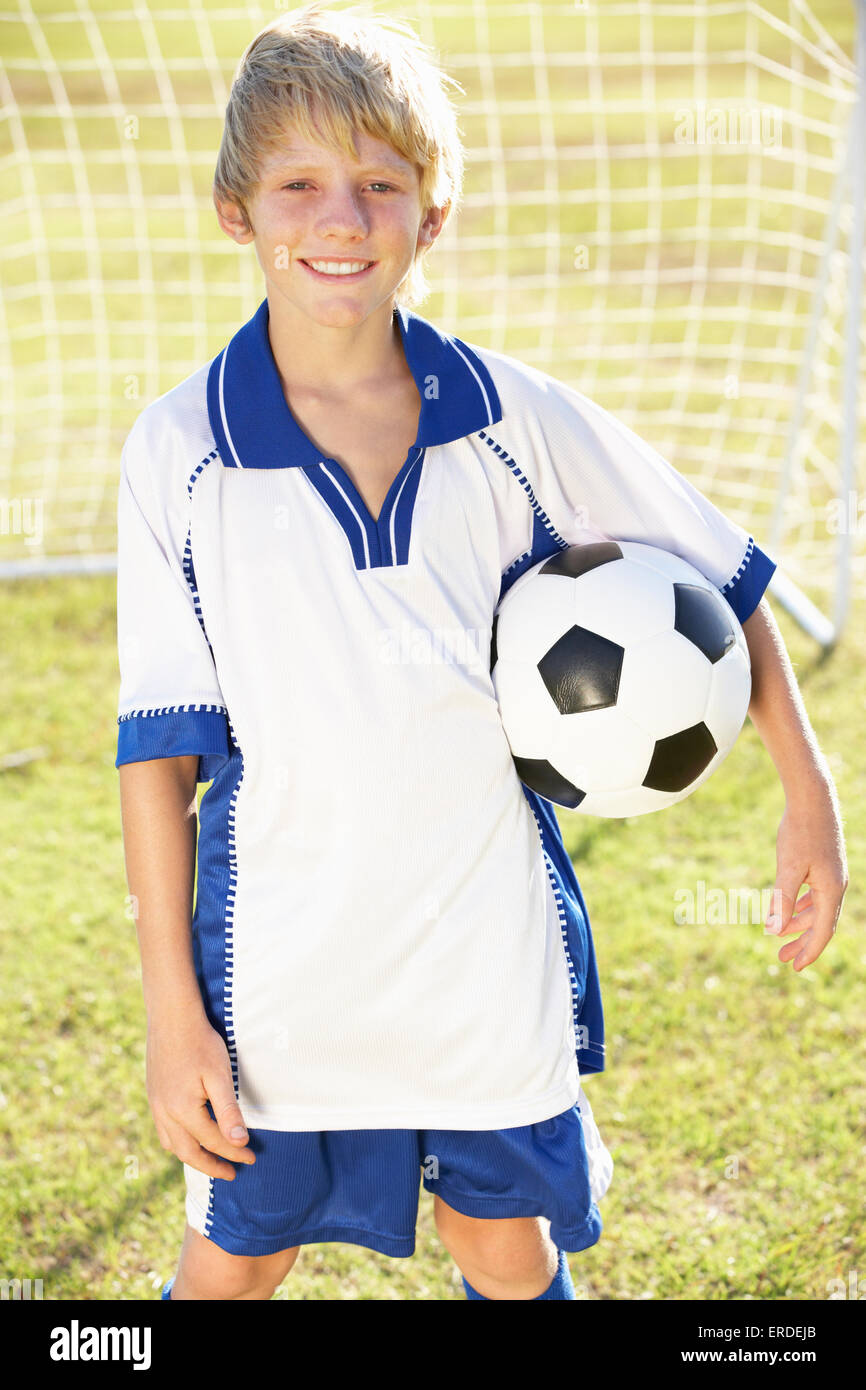 Young Boy Dressed In Soccer Kit Standing By Goal Stock Photo - Alamy