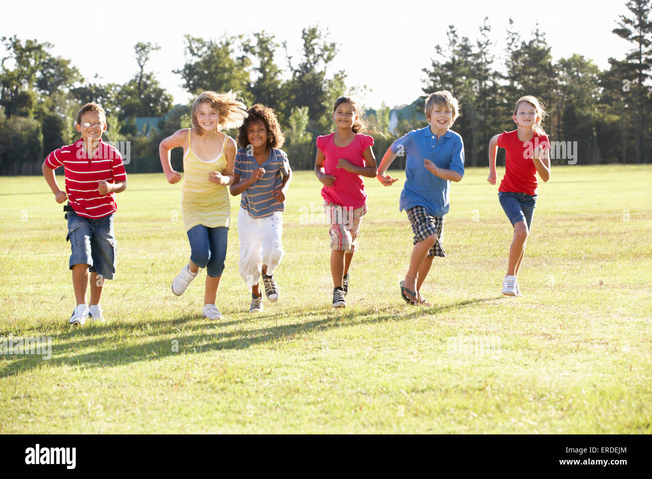 Group Of Children Running Through Countryside Stock Photo - Alamy
