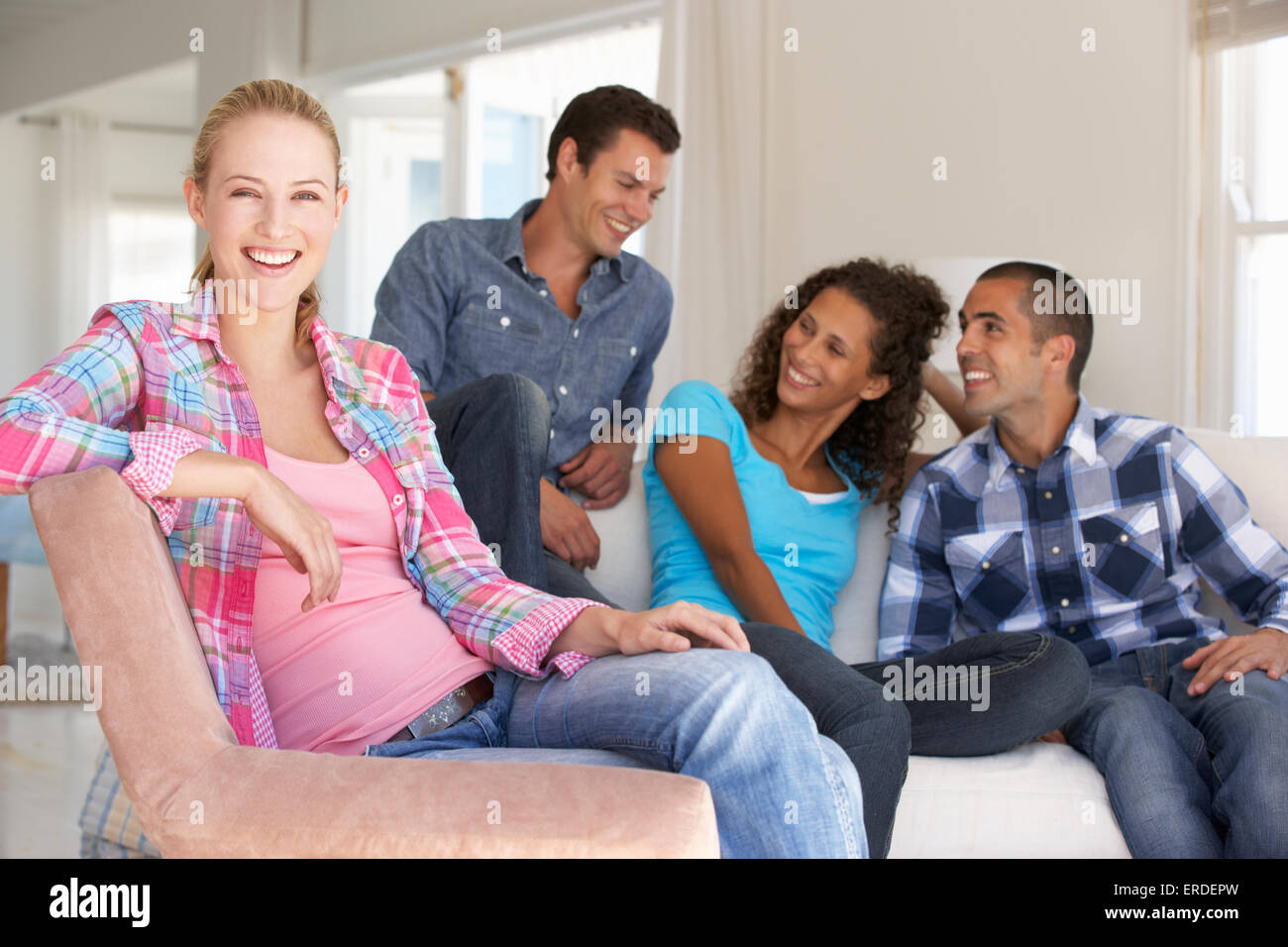 Group Of Friends Relaxing On Sofa At Home Together Stock Photo - Alamy