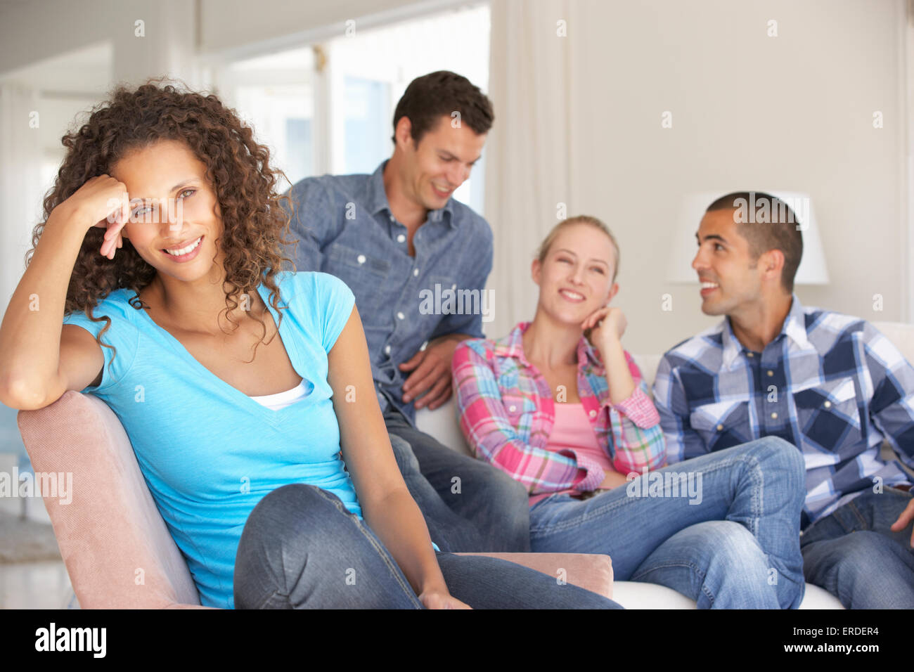 Group Of Friends Relaxing On Sofa At Home Together Stock Photo - Alamy