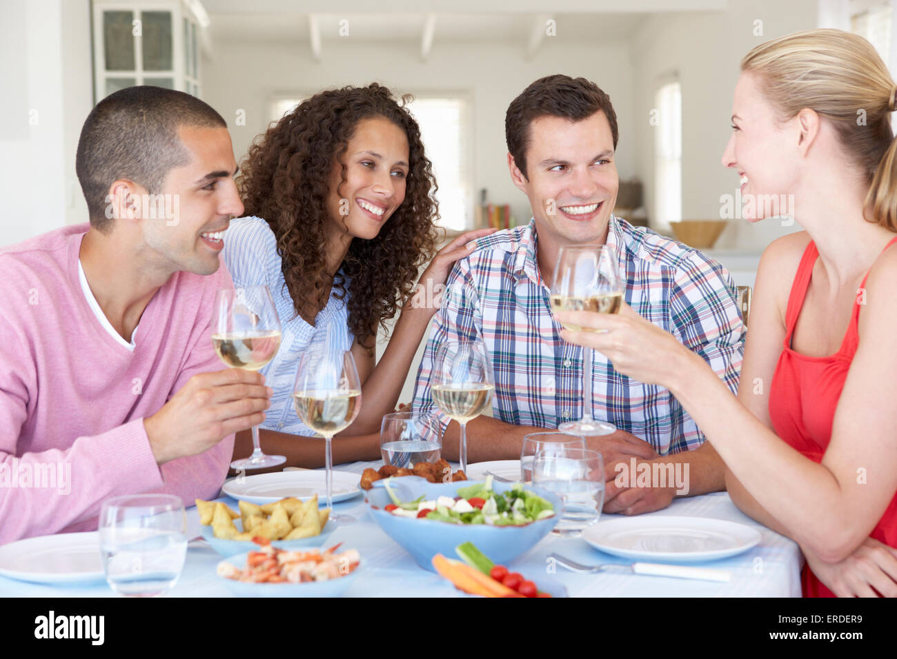 Group Of Young Friends Eating Meal At Home Stock Photo - Alamy