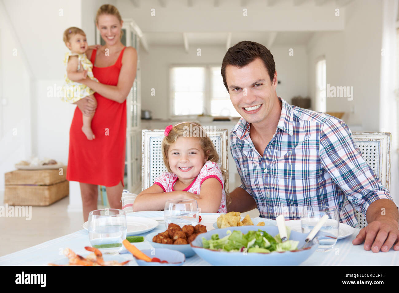 Family Enjoying Meal Together At Home Stock Photo - Alamy