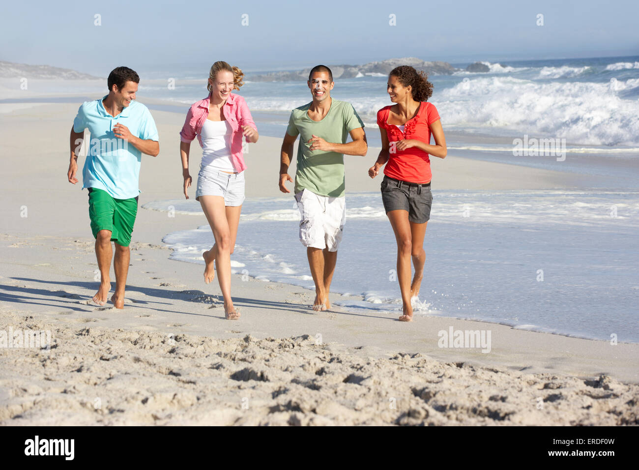 Young Friends Running Along Beach Stock Photo - Alamy