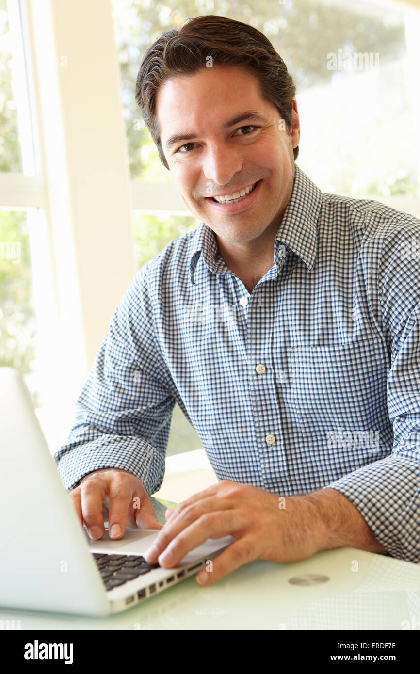 Hispanic Man Using Laptop In Home Office Stock Photo - Alamy