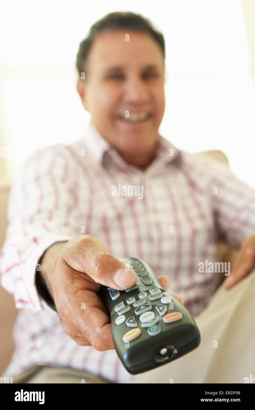Senior Hispanic Man Using TV Remote Control Stock Photo - Alamy