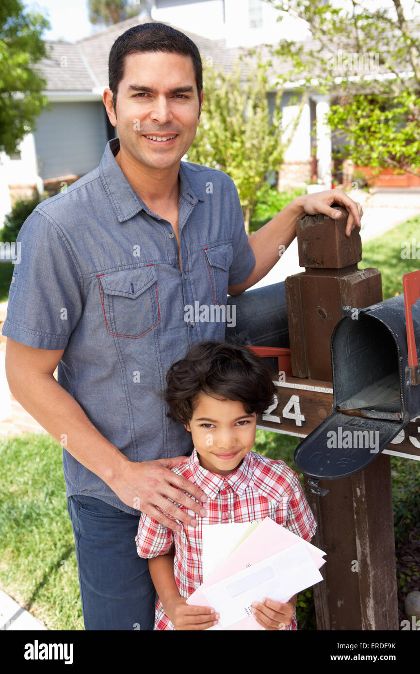 Hispanic Father And Son Checking Mailbox Stock Photo - Alamy