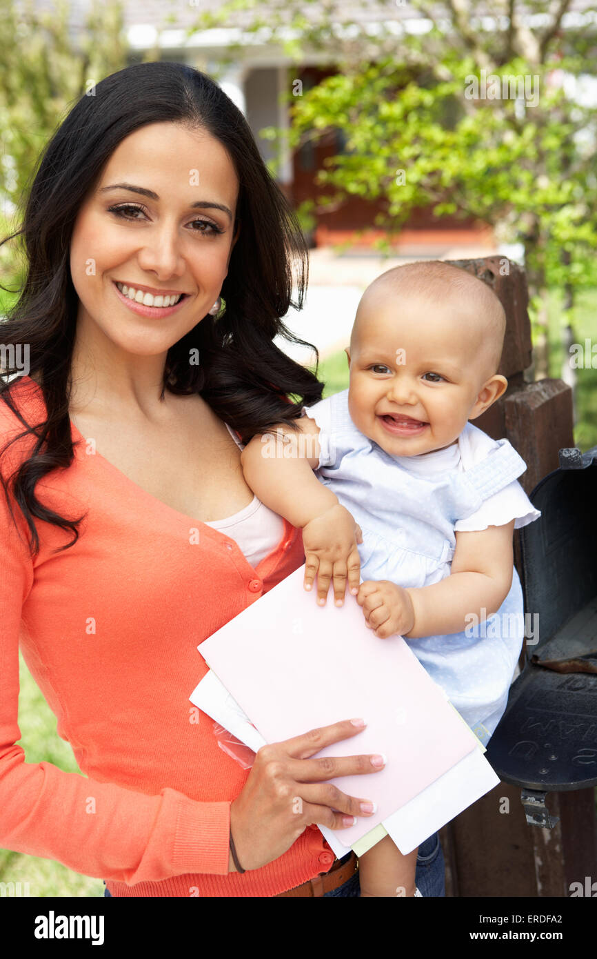 Hispanic Mother And Baby Checking Mailbox Stock Photo - Alamy