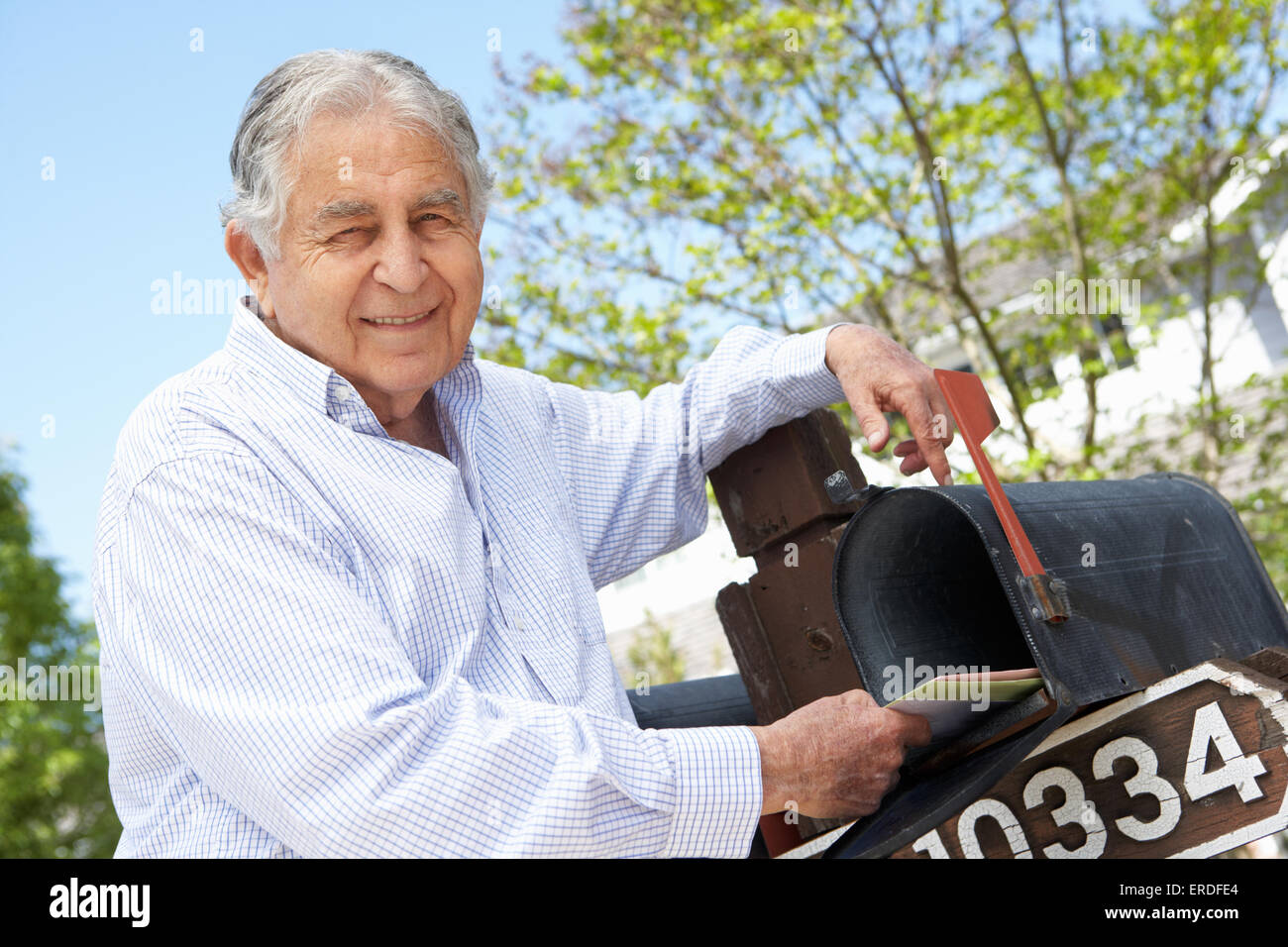 Senior man reading letter mailbox hi-res stock photography and images ...