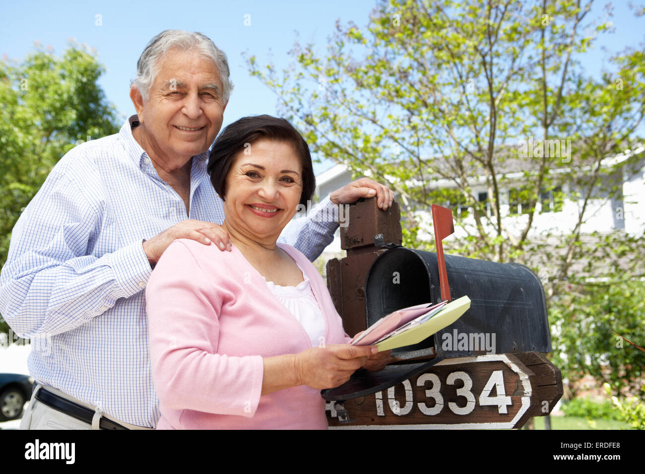 Senior Hispanic Couple Checking Mailbox Stock Photo - Alamy