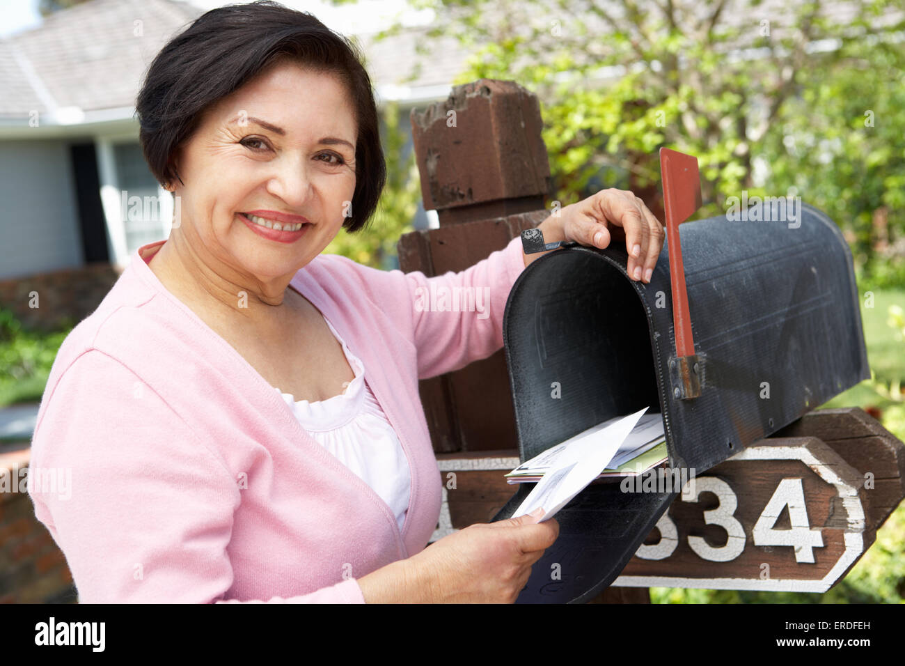 Senior Hispanic Woman Checking Mailbox Stock Photo - Alamy