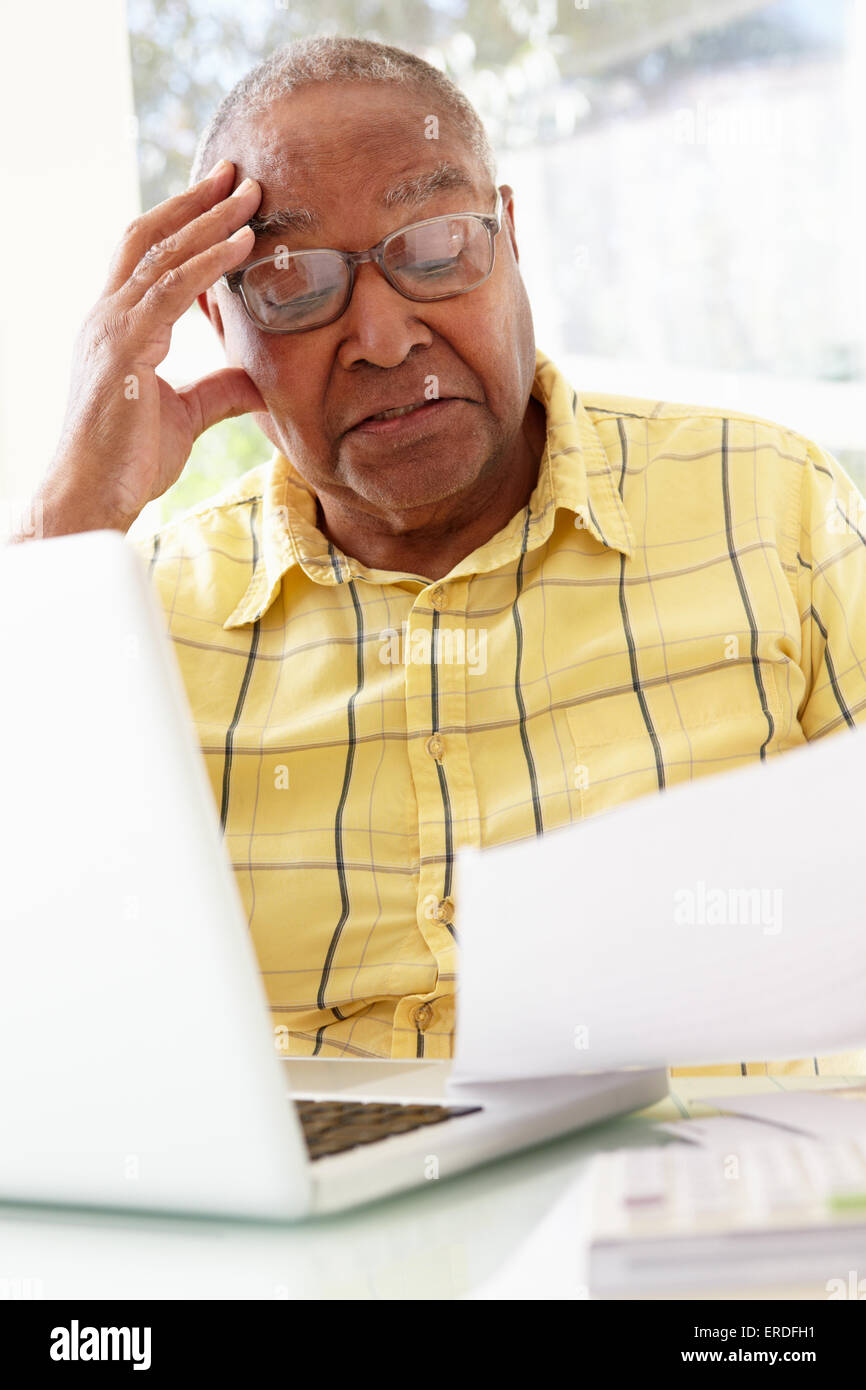 Worried Senior Studying Paperwork At Home Stock Photo - Alamy