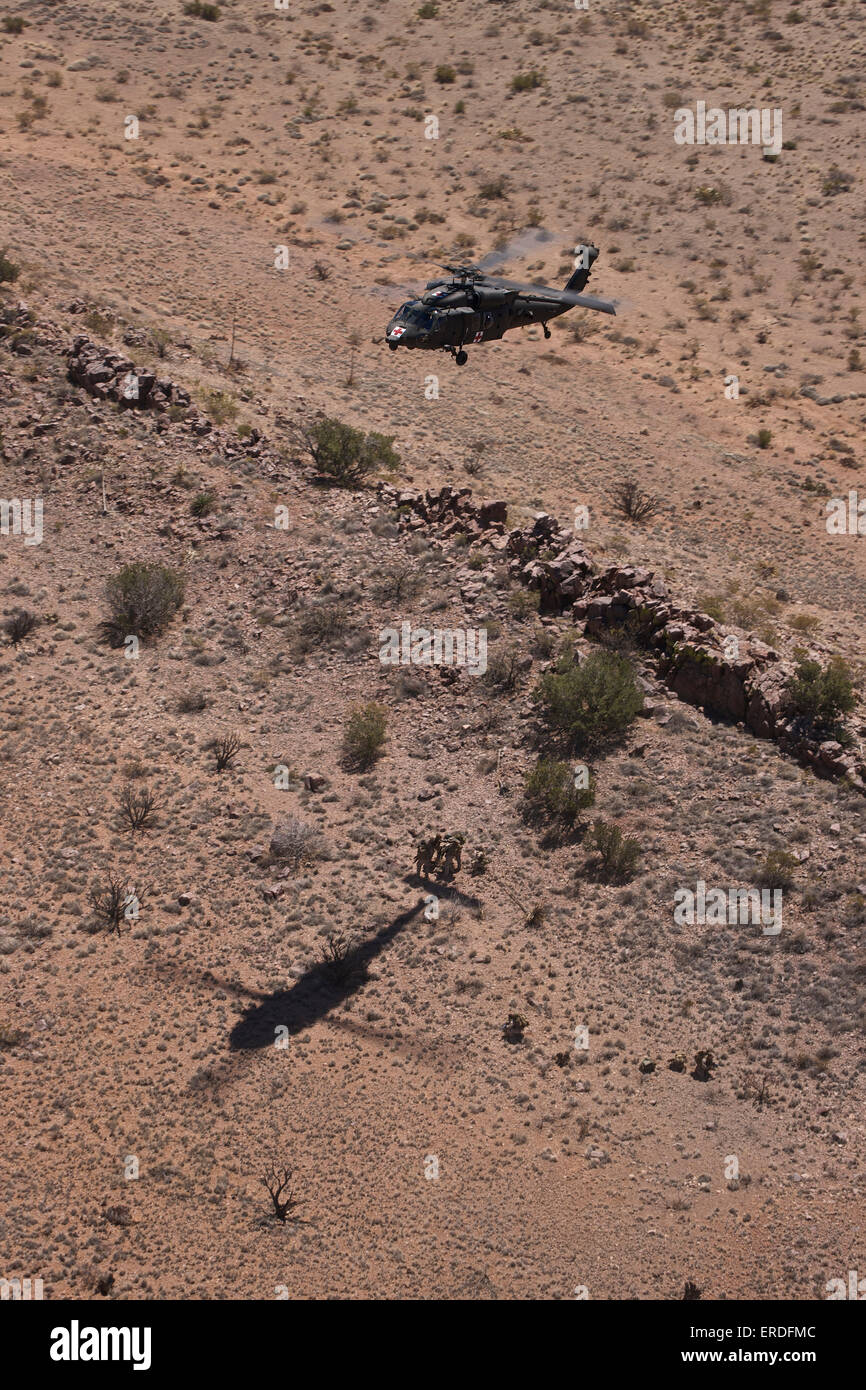 UH-60 Black Hawk hovers above U.S. Marines as they prepare to extract a ...