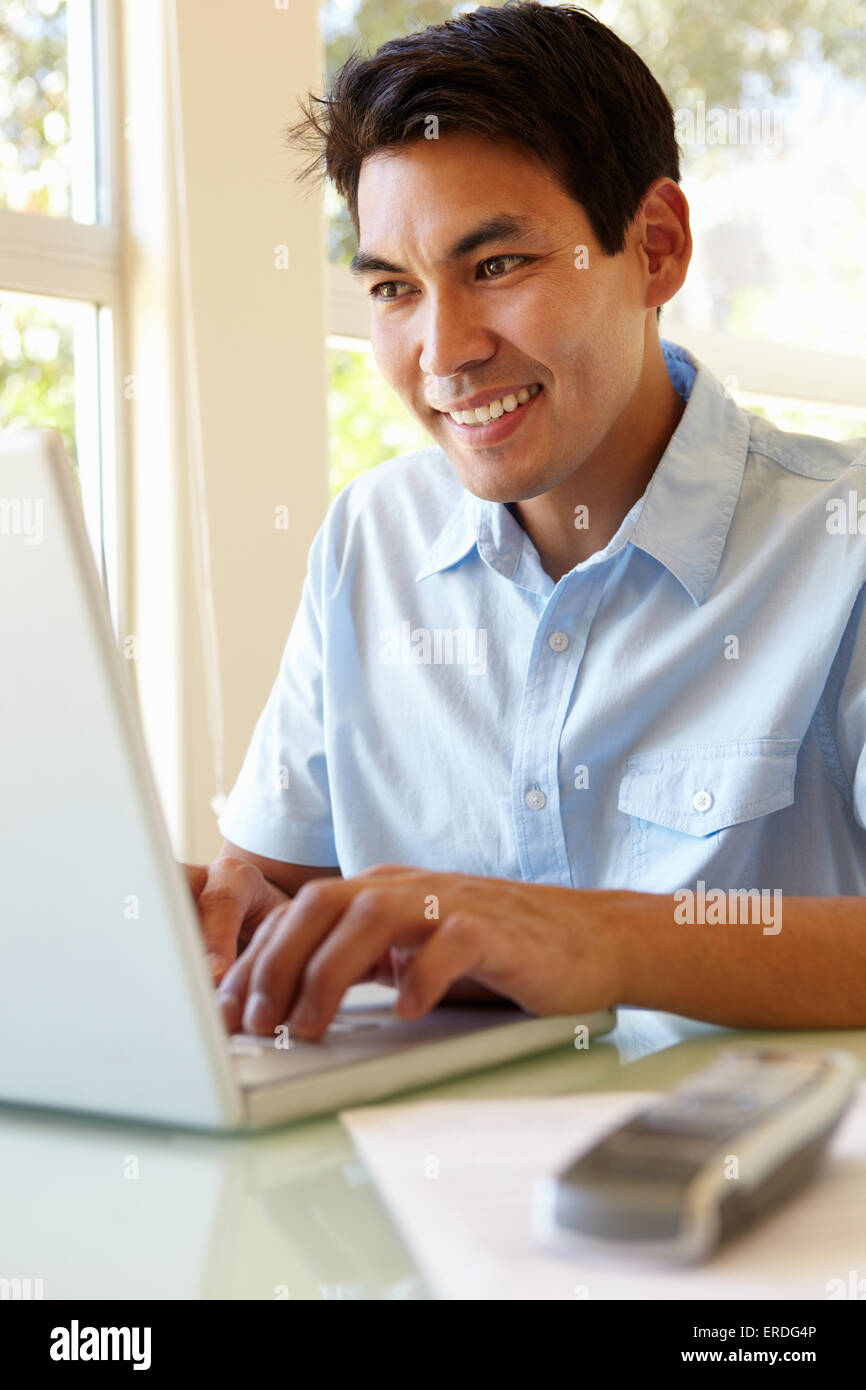 Filipino man working on laptop Stock Photo - Alamy