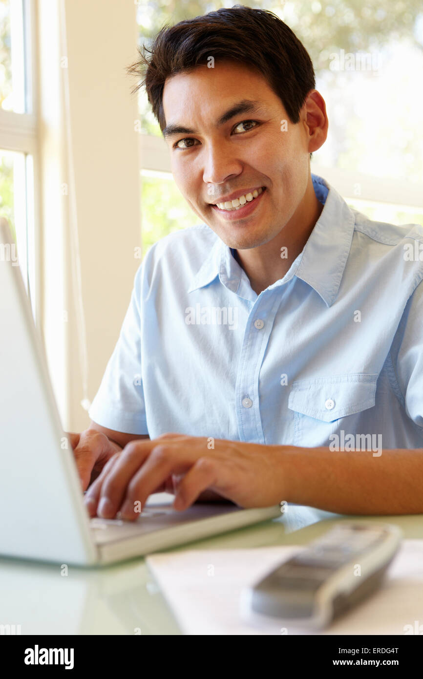 Filipino man working on laptop Stock Photo - Alamy