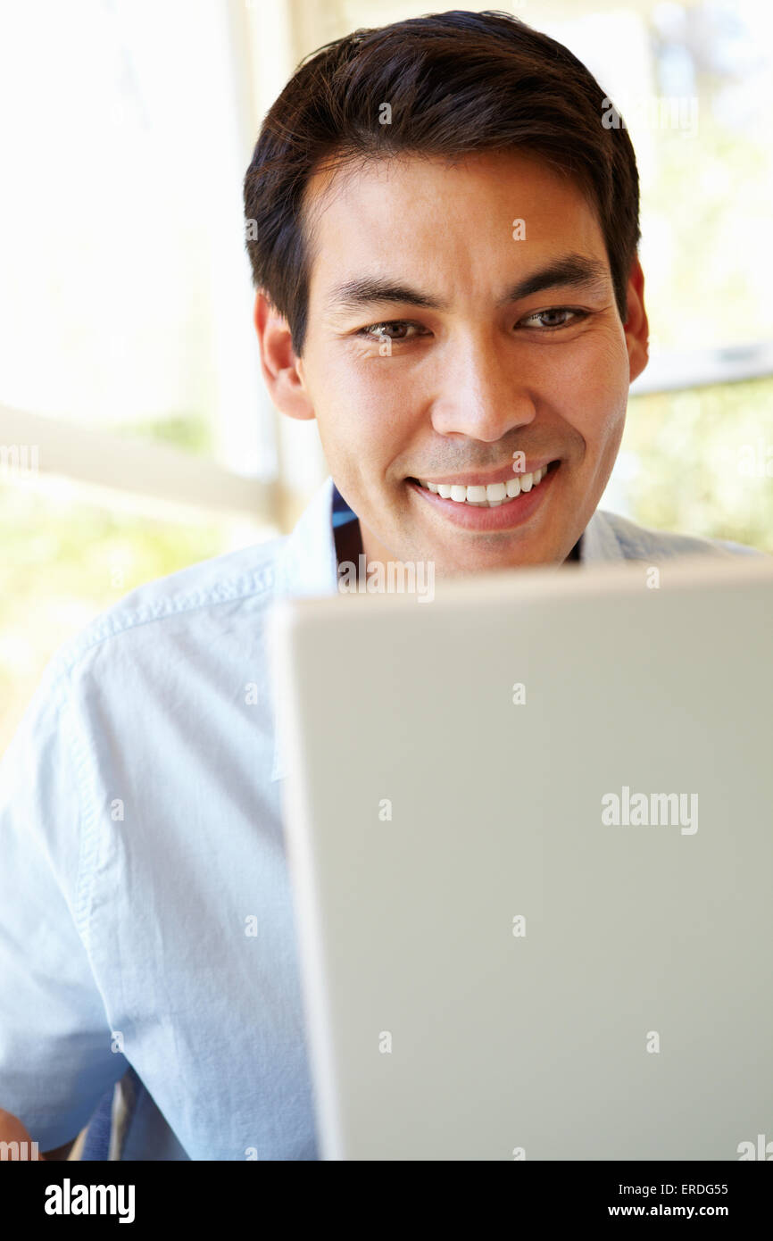Filipino man working on laptop Stock Photo - Alamy
