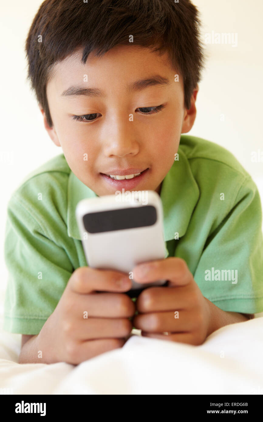 Young boy using smartphone Stock Photo - Alamy