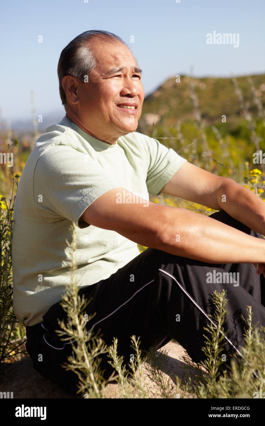 Senior man sitting outdoors Stock Photo - Alamy