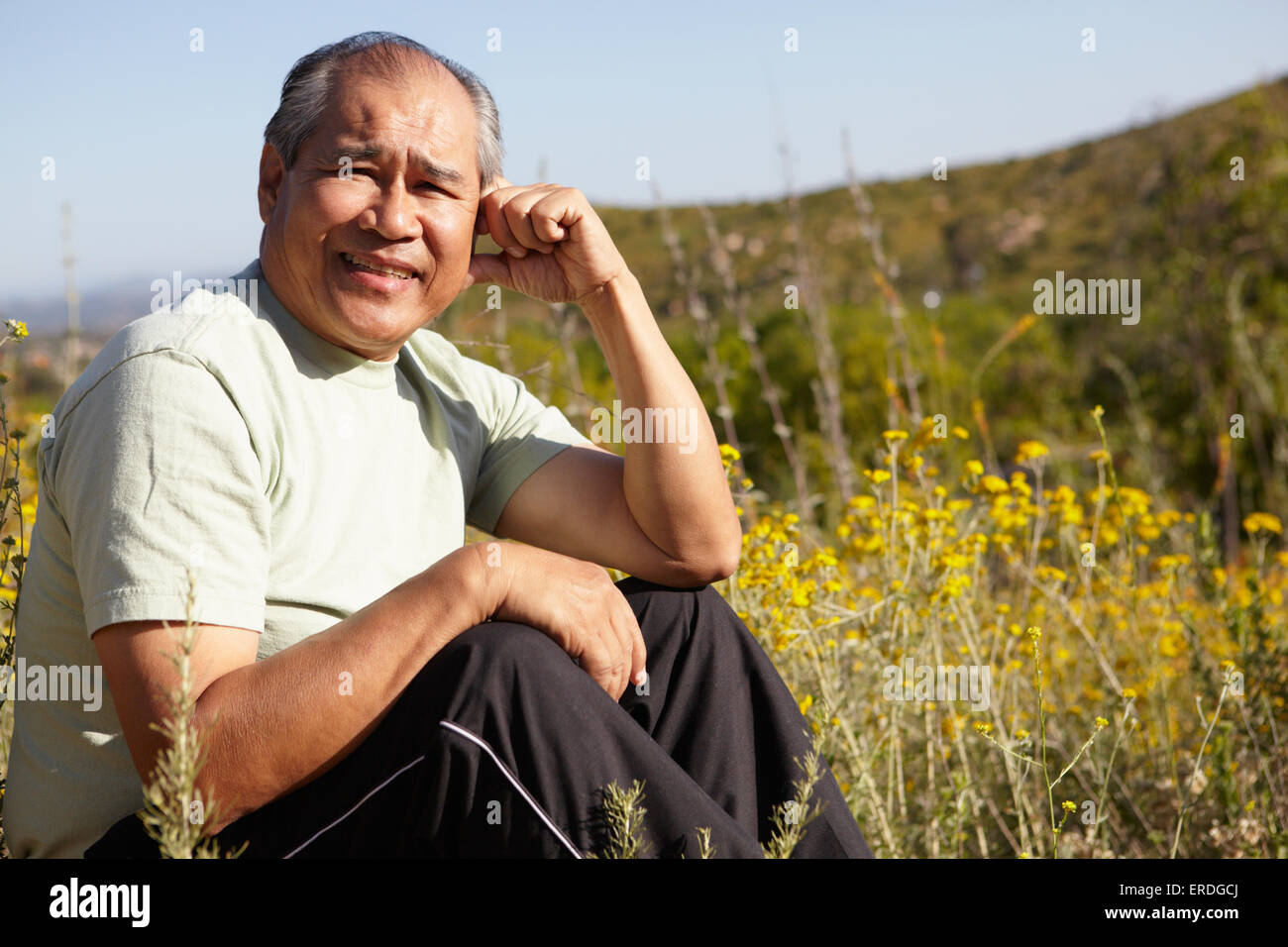 Senior man sitting outdoors Stock Photo - Alamy
