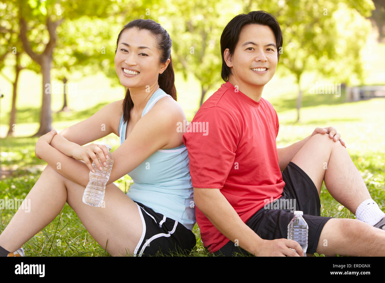 Asian couple resting after exercise Stock Photo - Alamy