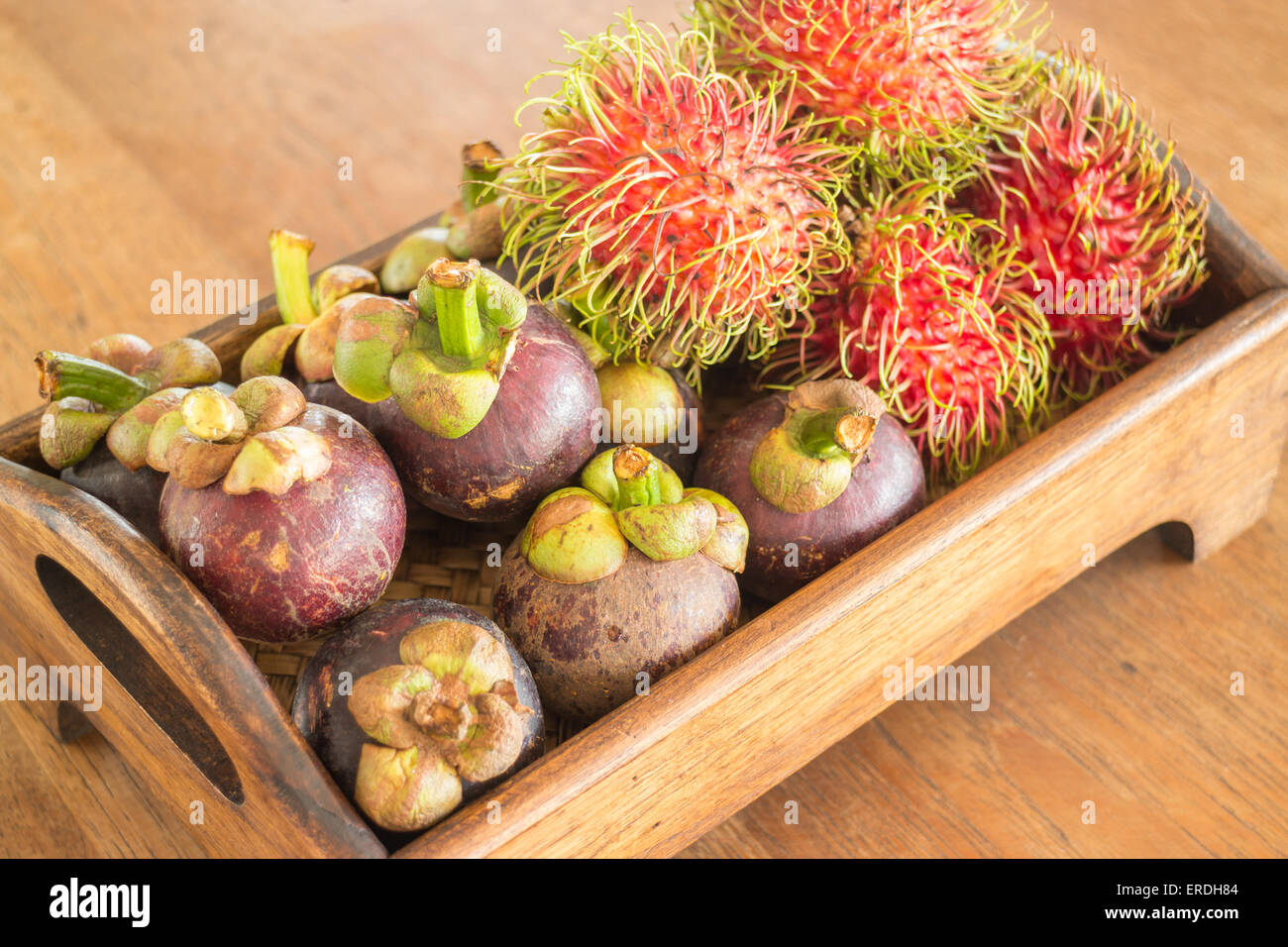 Fresh mangosteen and ranbutan on wooden tray, stock photo Stock Photo ...