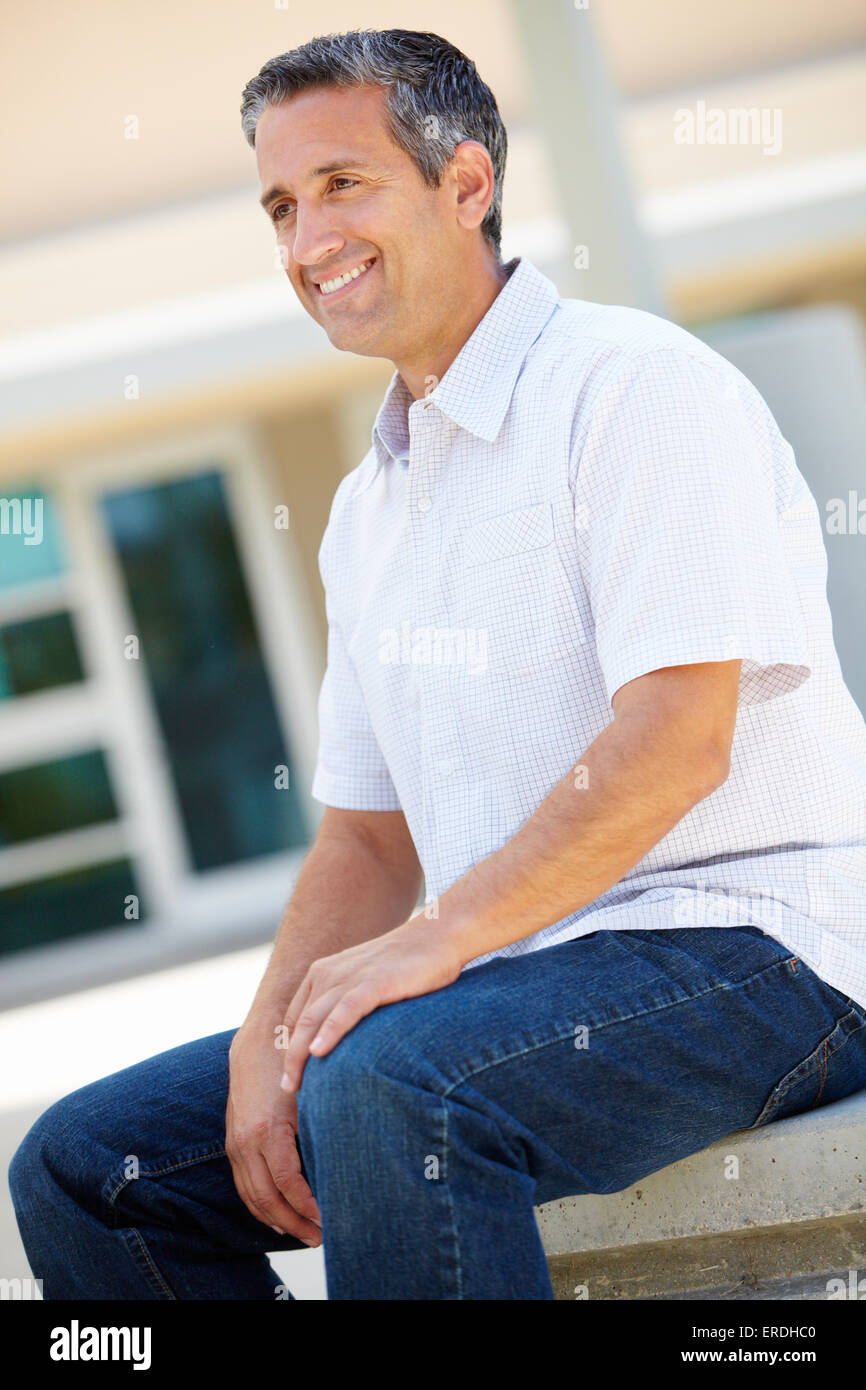 Portrait man sitting outdoors Stock Photo - Alamy
