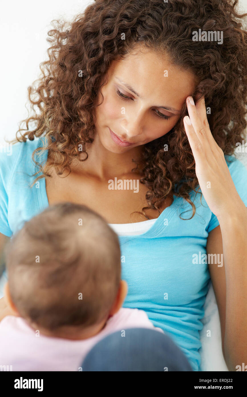 Stressed Mother At Home With Baby Stock Photo - Alamy