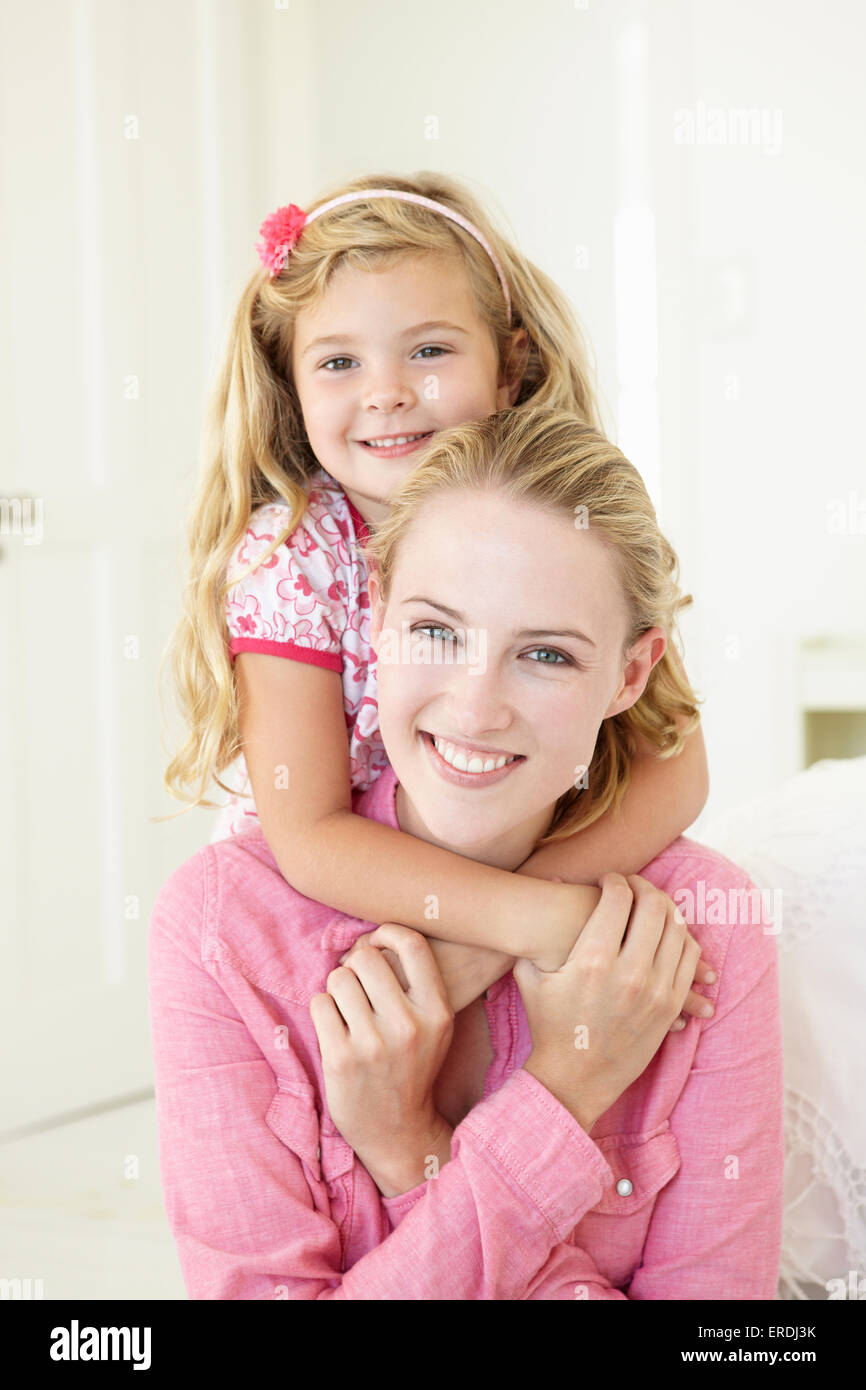 Mother And Daughter Having Cuddle Together At Home Stock Photo - Alamy