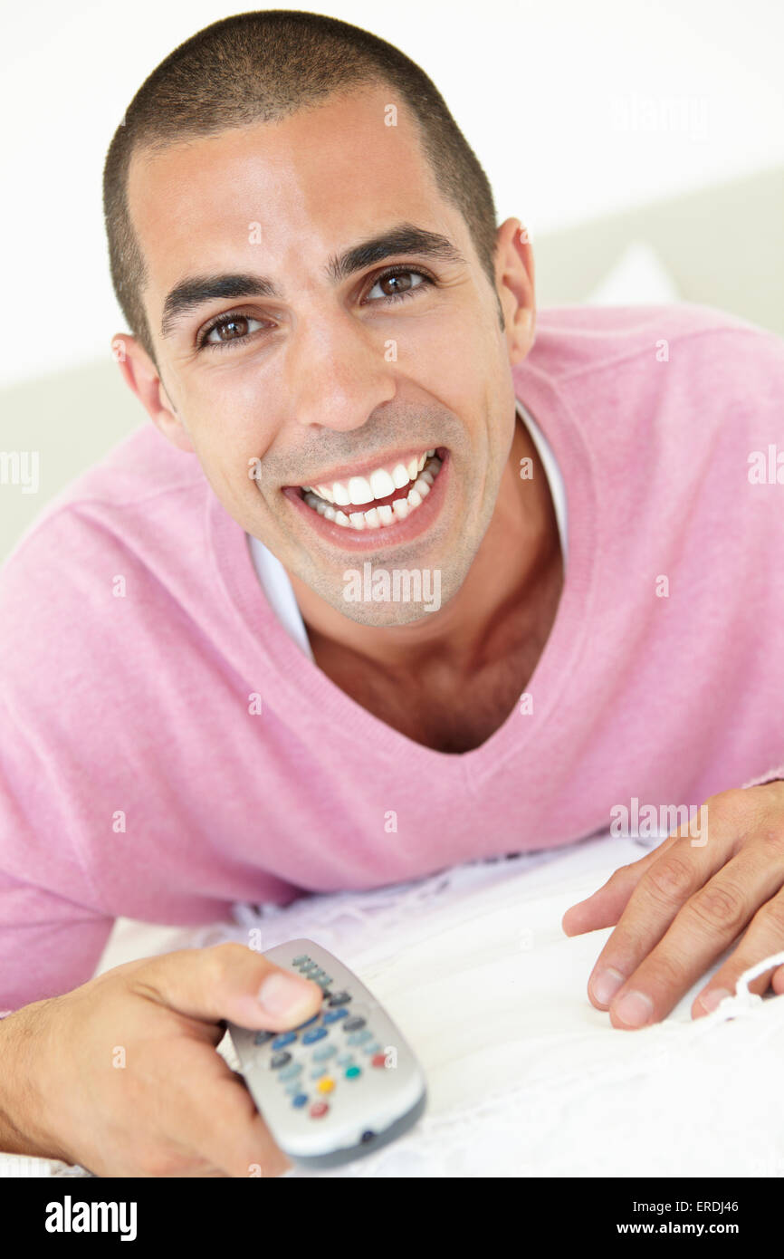 Young Man Relaxing On Bed Watching TV Stock Photo - Alamy