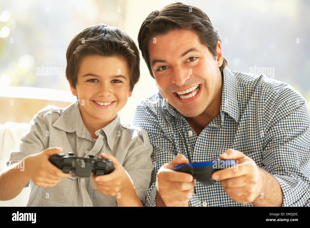 Father And Son Playing Video Game At Home Stock Photo - Alamy