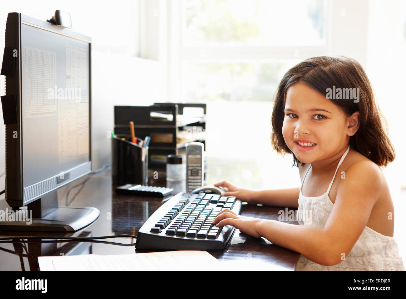 Young Hispanic girl using computer at home Stock Photo - Alamy