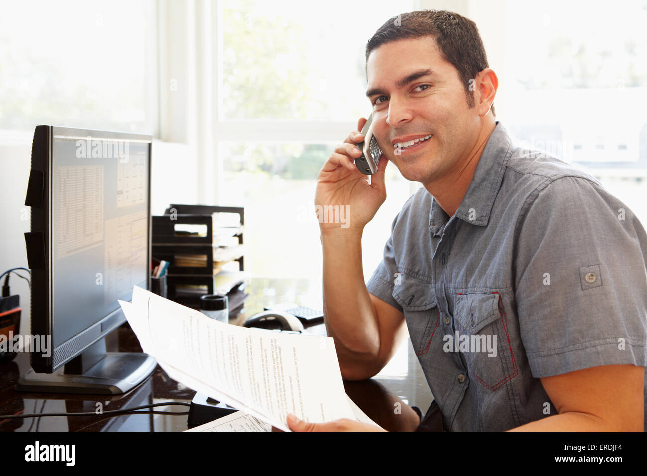 Hispanic man working in home office Stock Photo - Alamy