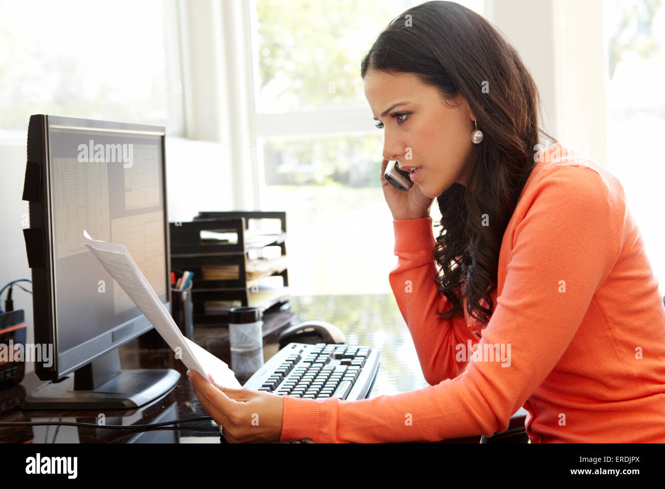 Hispanic woman working in home office Stock Photo - Alamy