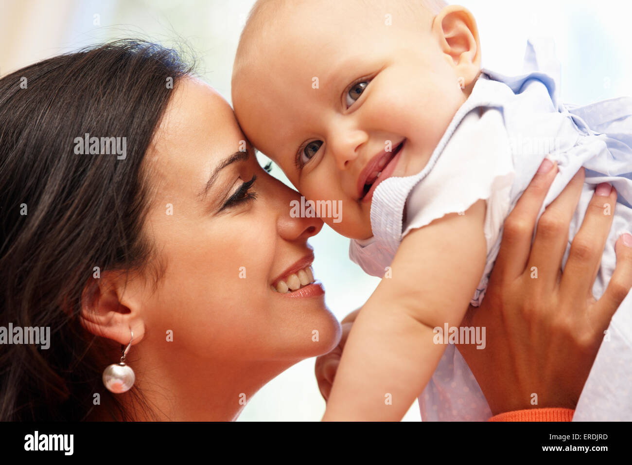 Hispanic mother and baby at home Stock Photo - Alamy
