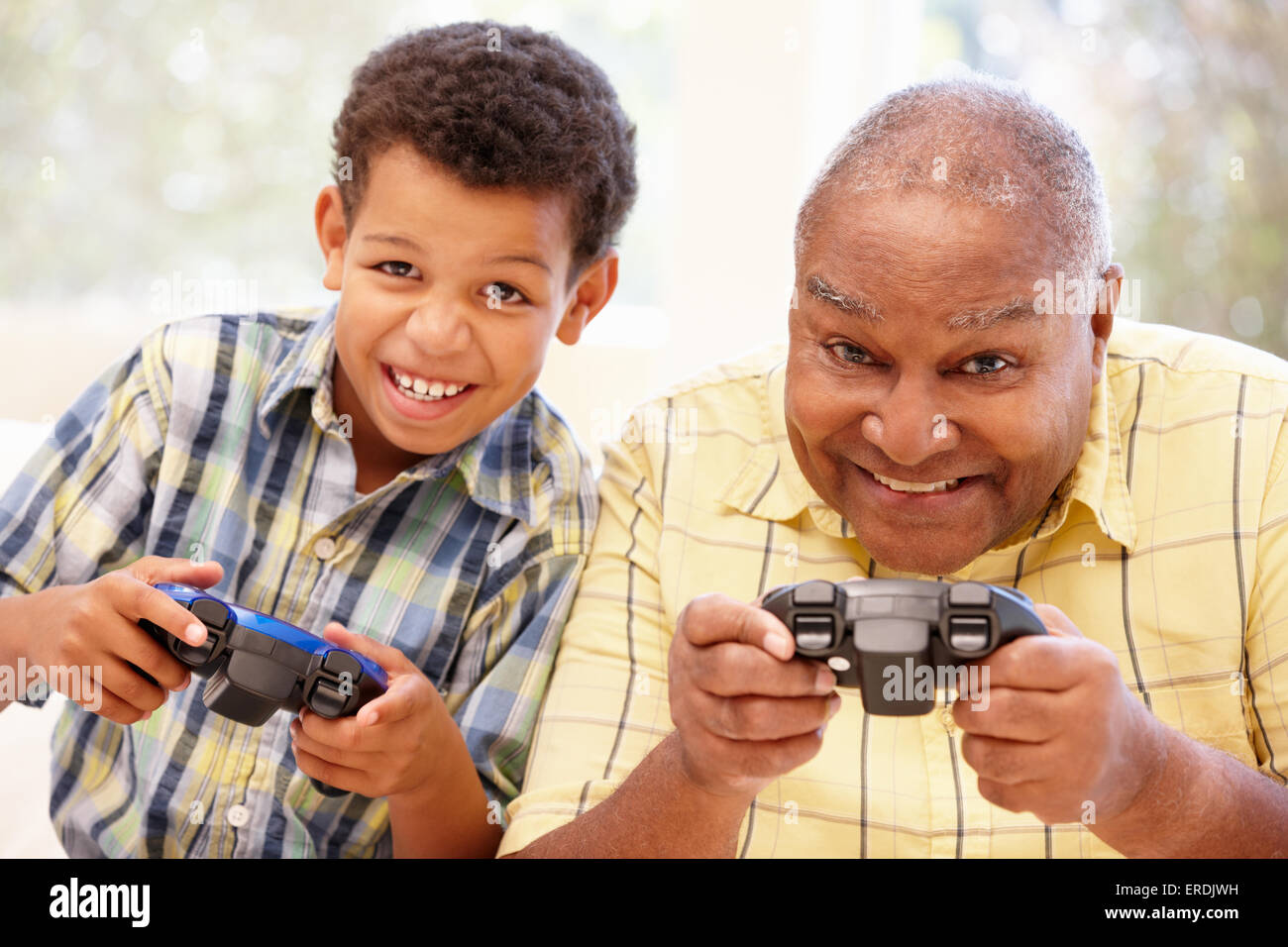 Grandfather and grandson playing computer games Stock Photo - Alamy