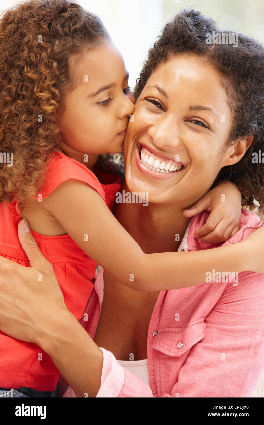Mixed race girl kissing mother Stock Photo - Alamy
