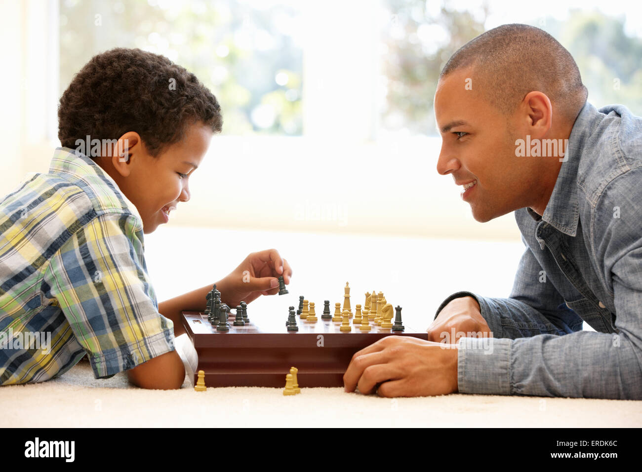 Father playing chess with son Stock Photo - Alamy