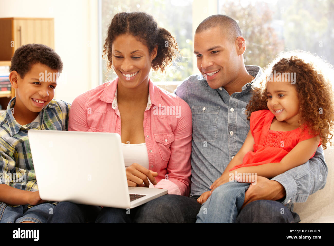 Family working on laptop at home Stock Photo - Alamy