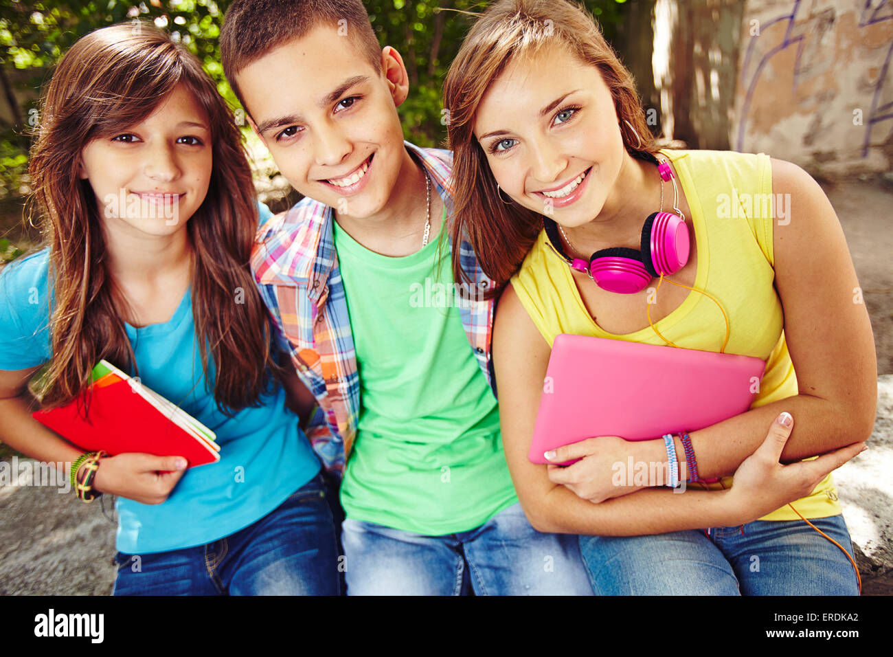Happy school friends looking at camera Stock Photo - Alamy