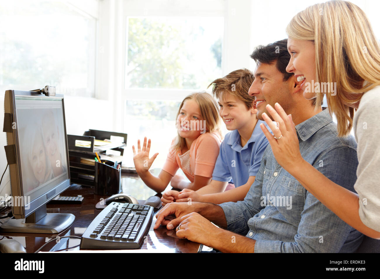 Family using skype in home office Stock Photo - Alamy