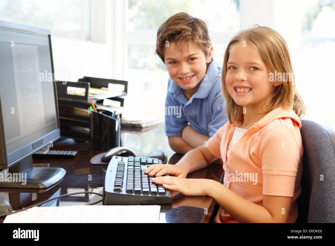 Young boy and girl using computer at home Stock Photo - Alamy