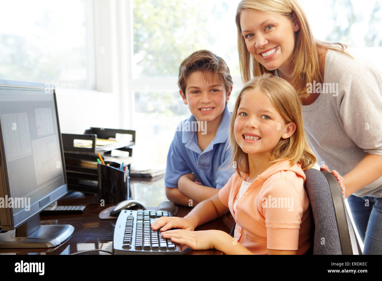 Mother and children using computer at home Stock Photo - Alamy