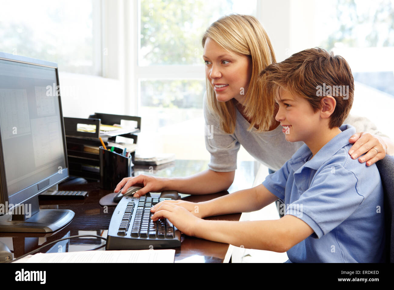Mother and son using computer at home Stock Photo - Alamy