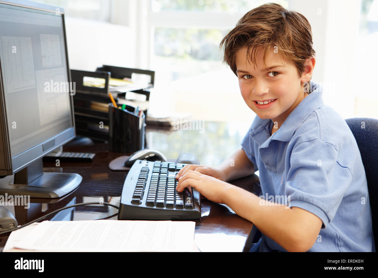 Young boy using computer at home Stock Photo - Alamy