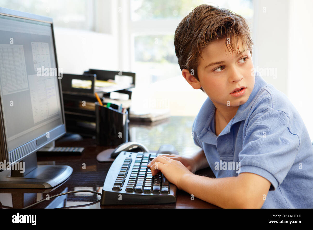 Young boy using computer at home Stock Photo - Alamy