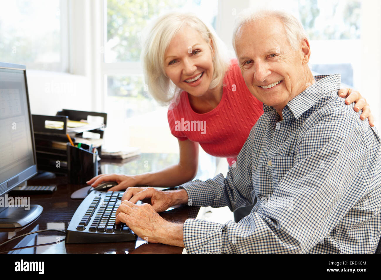 Senior man and daughter using computer at home Stock Photo - Alamy