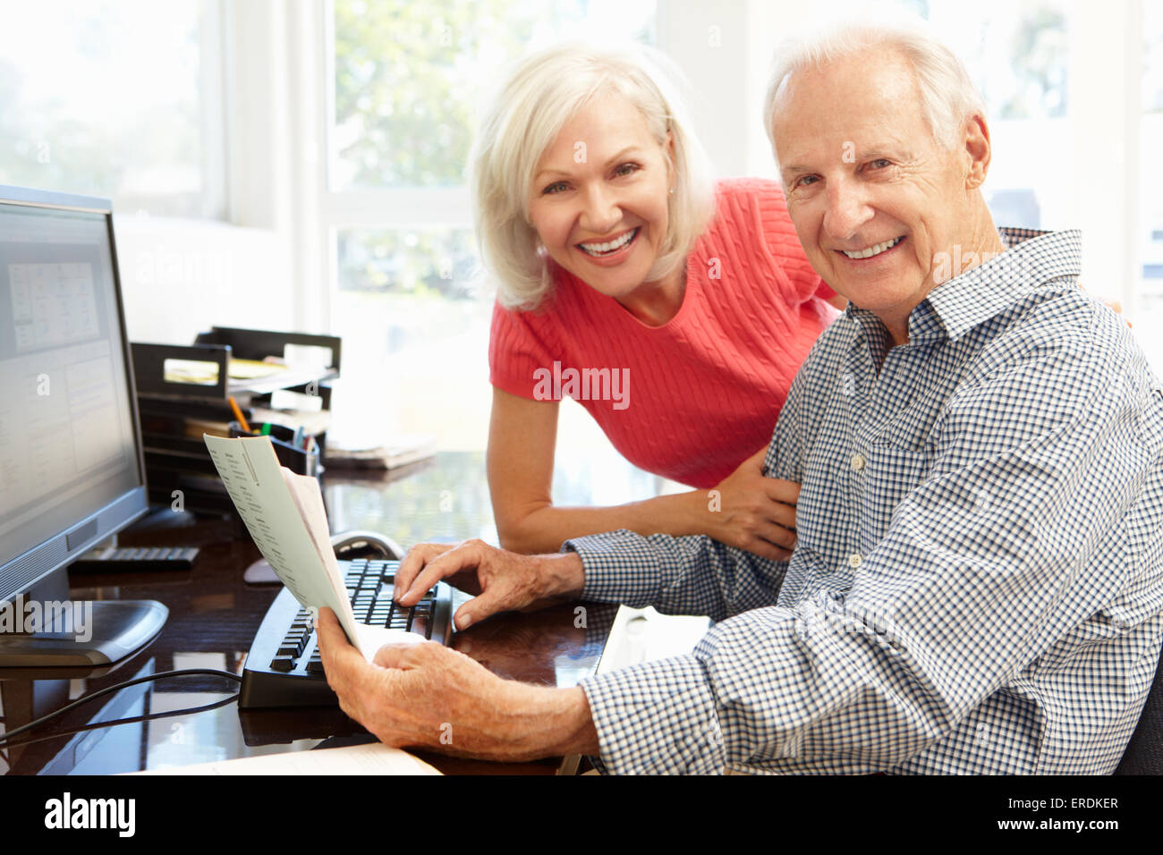 Senior man and daughter using computer at home Stock Photo - Alamy