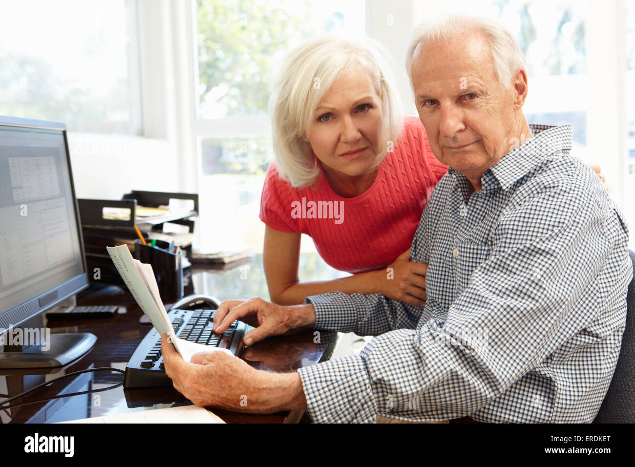 Senior man and daughter using computer at home Stock Photo - Alamy