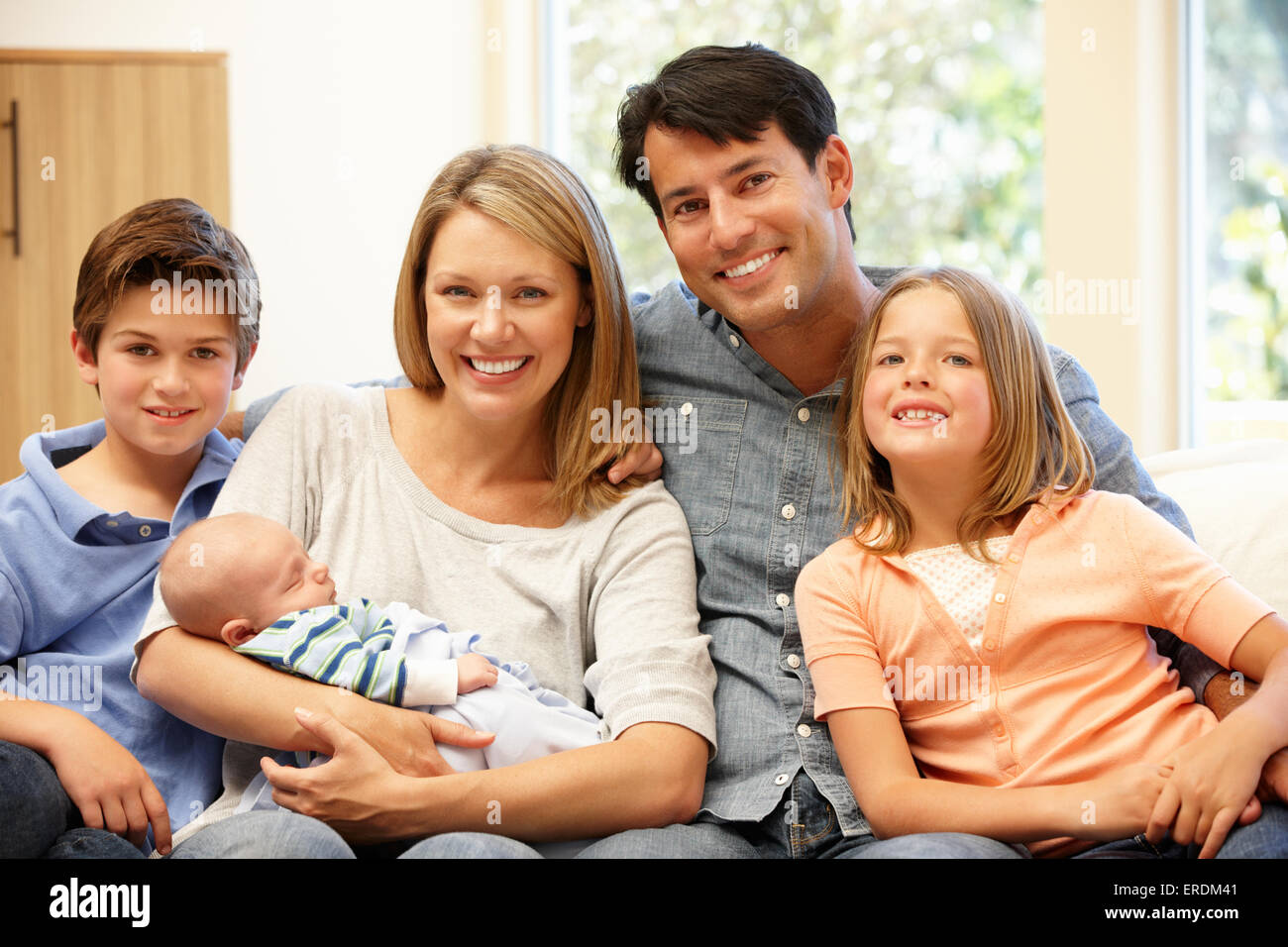 Family at home with new baby Stock Photo - Alamy