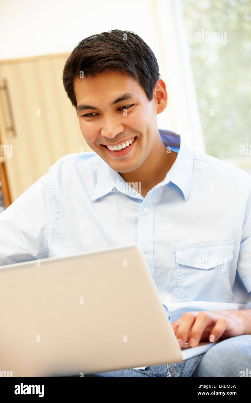 Man using laptop home asian hi-res stock photography and images - Alamy