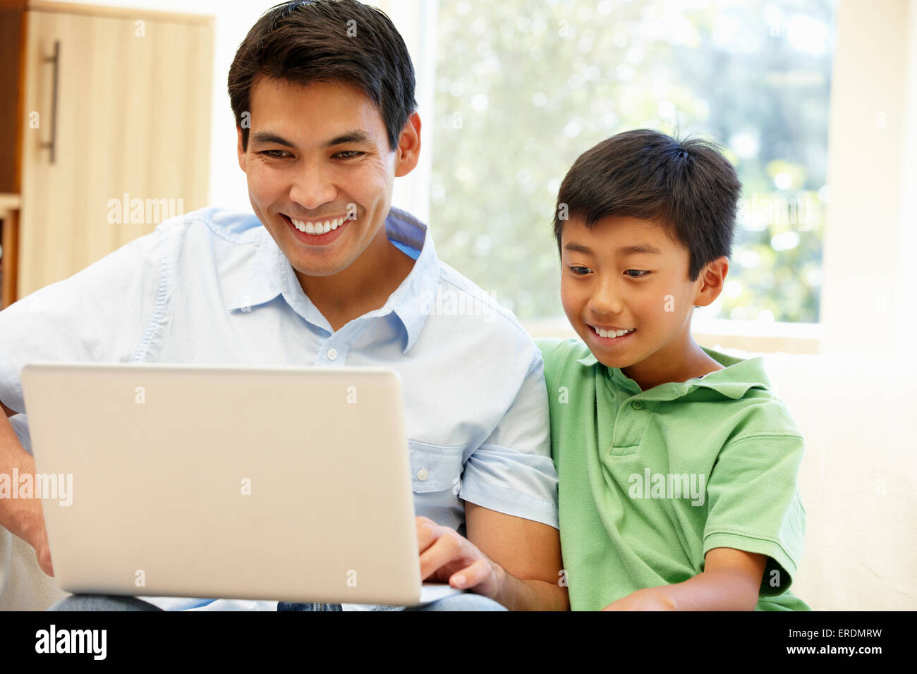 Father and son using laptop Stock Photo - Alamy